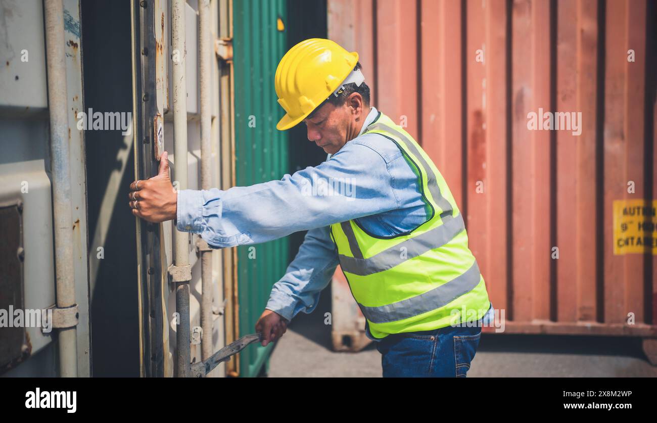 Portrait of Engineer or foreman wears PPE checking container storage ...