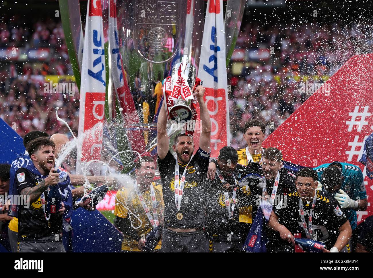 Southampton captain Jack Stephens lifts the trophy with team-mates ...