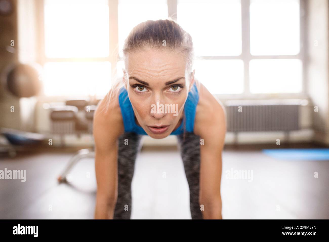 Beautiful sport woman exercising in gym. Routine workout for woman's ...