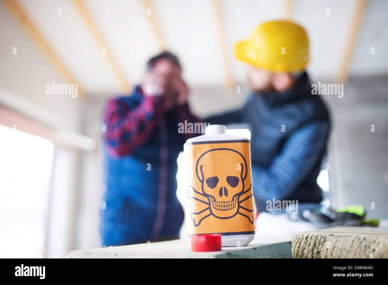 Colleague giving first aid to worker with chemical splashed on his skin ...