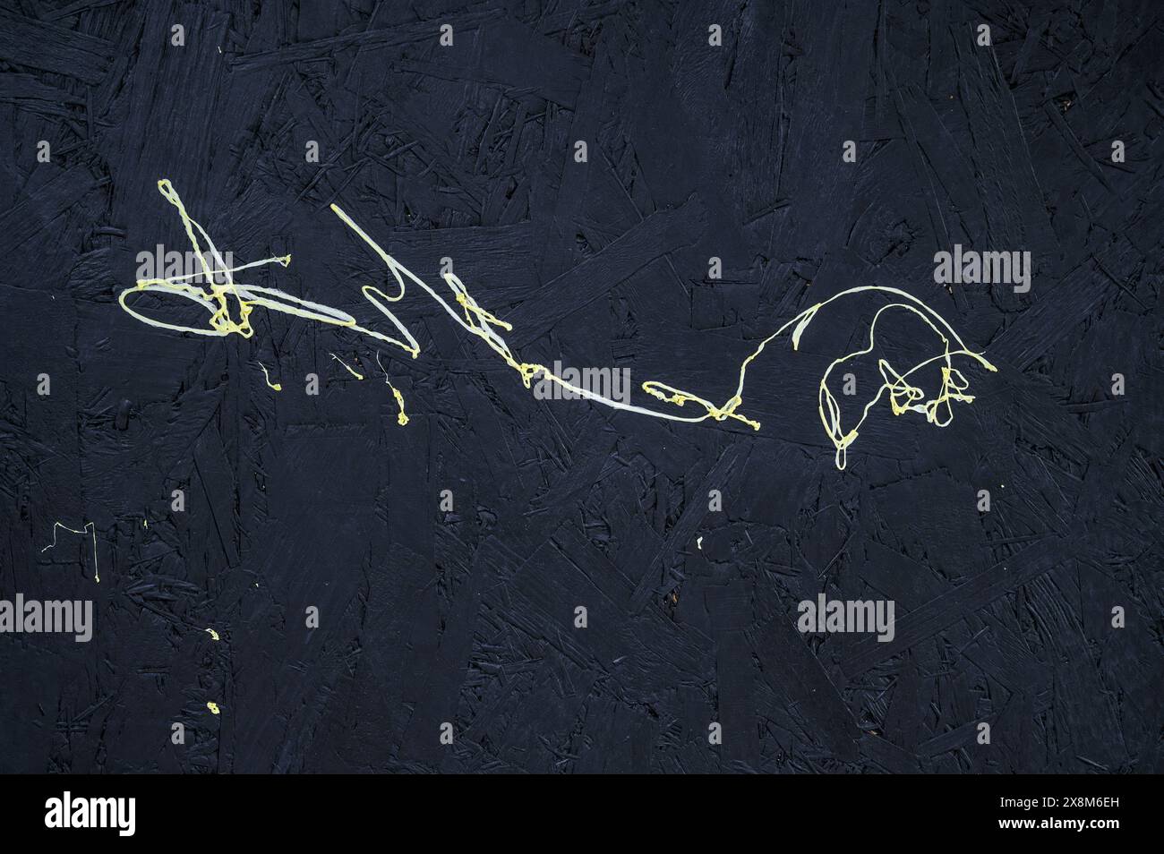 Abstract yellow squiggle on a black background Stock Photo - Alamy