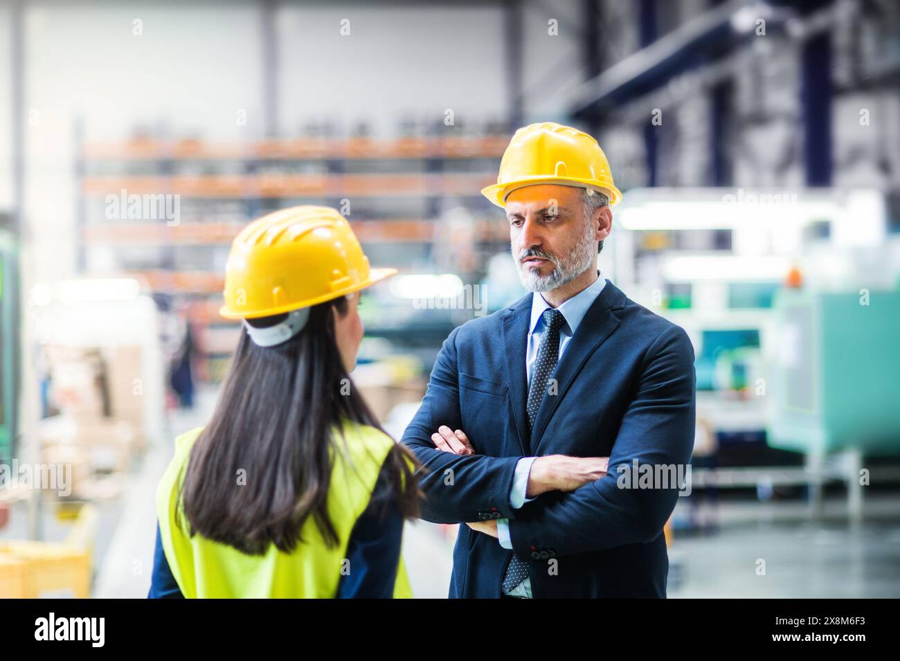 Warehouse worker talking with logistics employee in warehouse, planning ...