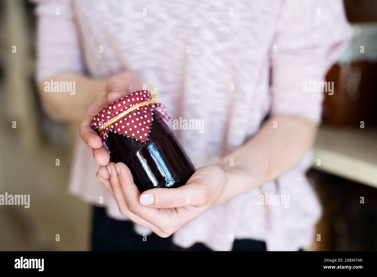 Female customer shopping in package-free store using reusable ...