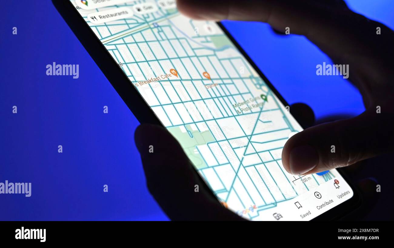 Poznan, Poland - 13 January: Girl using google maps app on a smartphone ...
