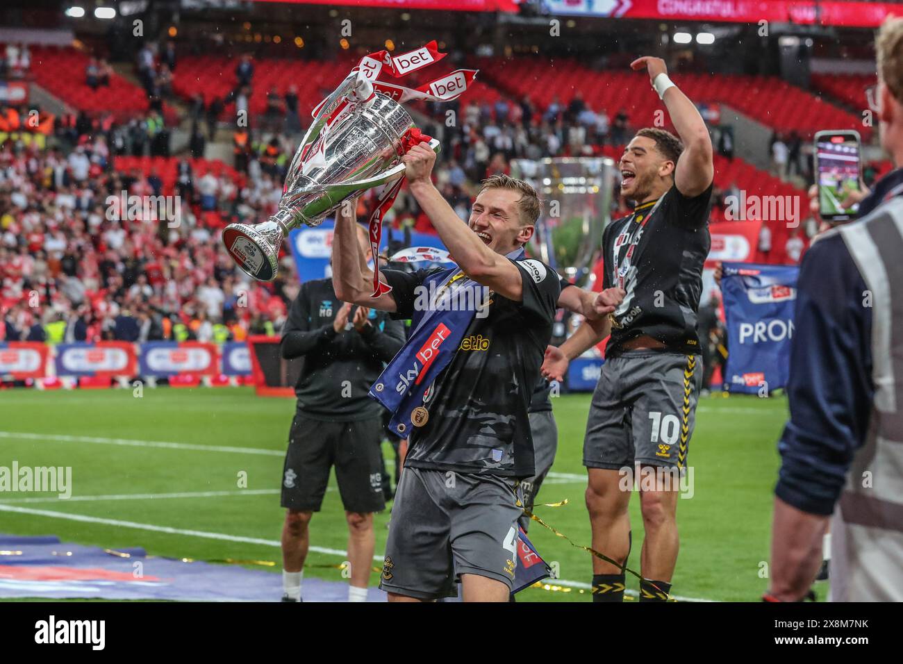 Flynn Downes of Southampton lifts the trophy in front of the ...