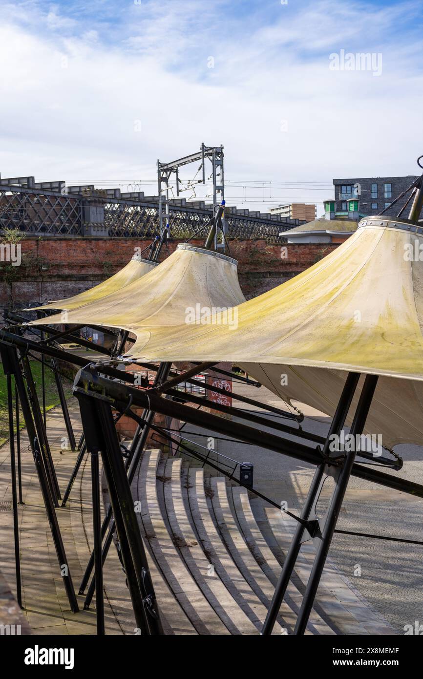 Modern urban outdoor amphitheatre with canvas canopies, metal ...