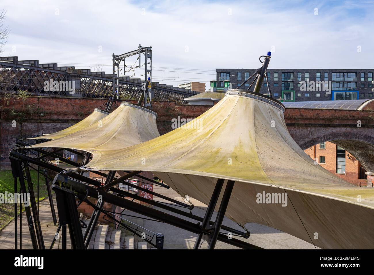 Urban scene: white canopies over amphitheatre Castle field Manchester ...