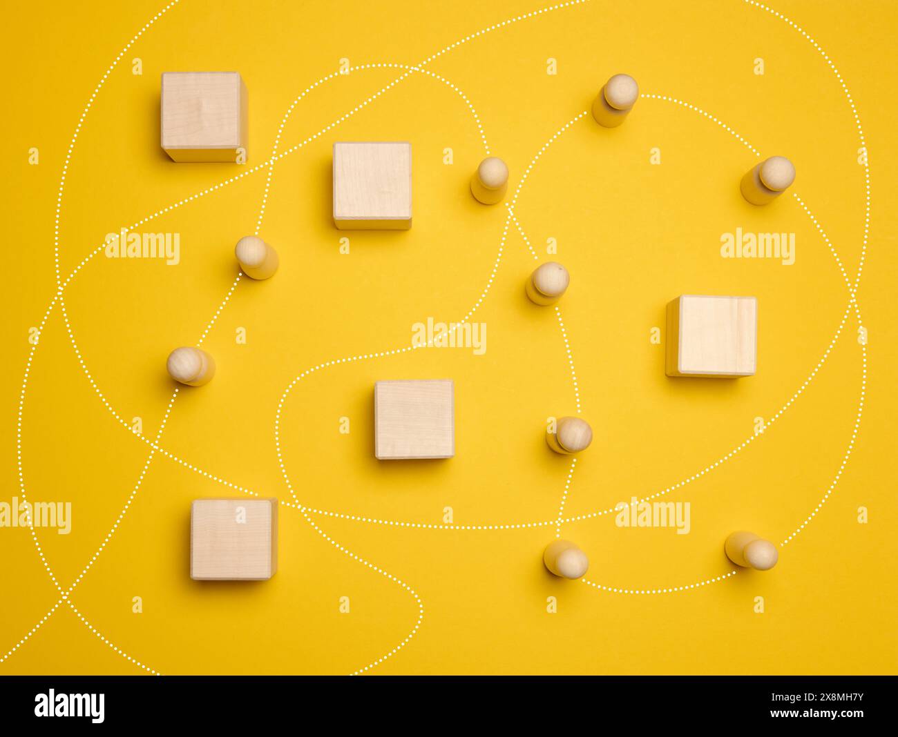 Wooden figures of men and a trajectory between obstacles on a yellow ...