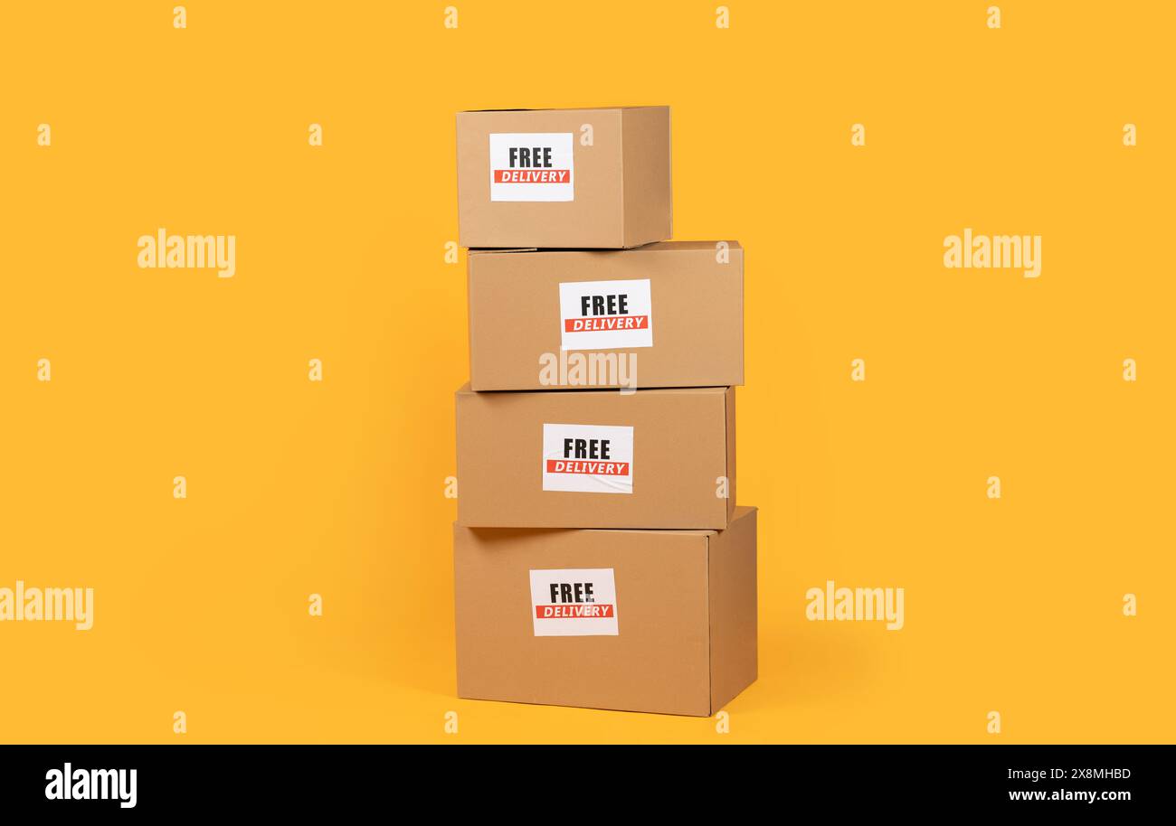 Four Paper Boxes Stacked on Yellow Background Stock Photo - Alamy
