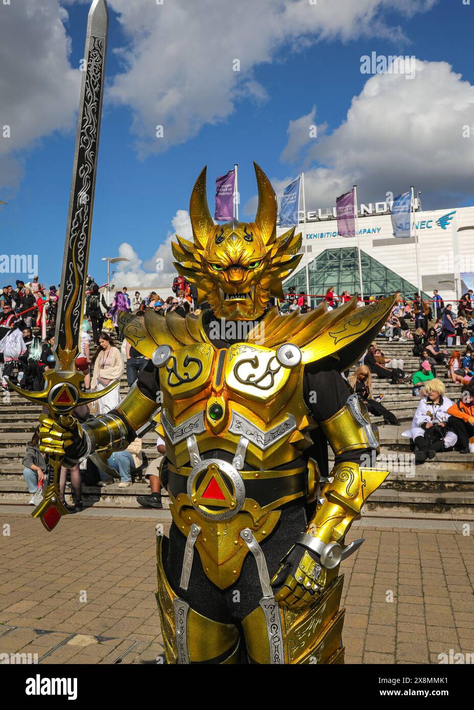 London, UK. 26th May, 2024. A cosplayer in 'Iron Warrior' outfit poses ...