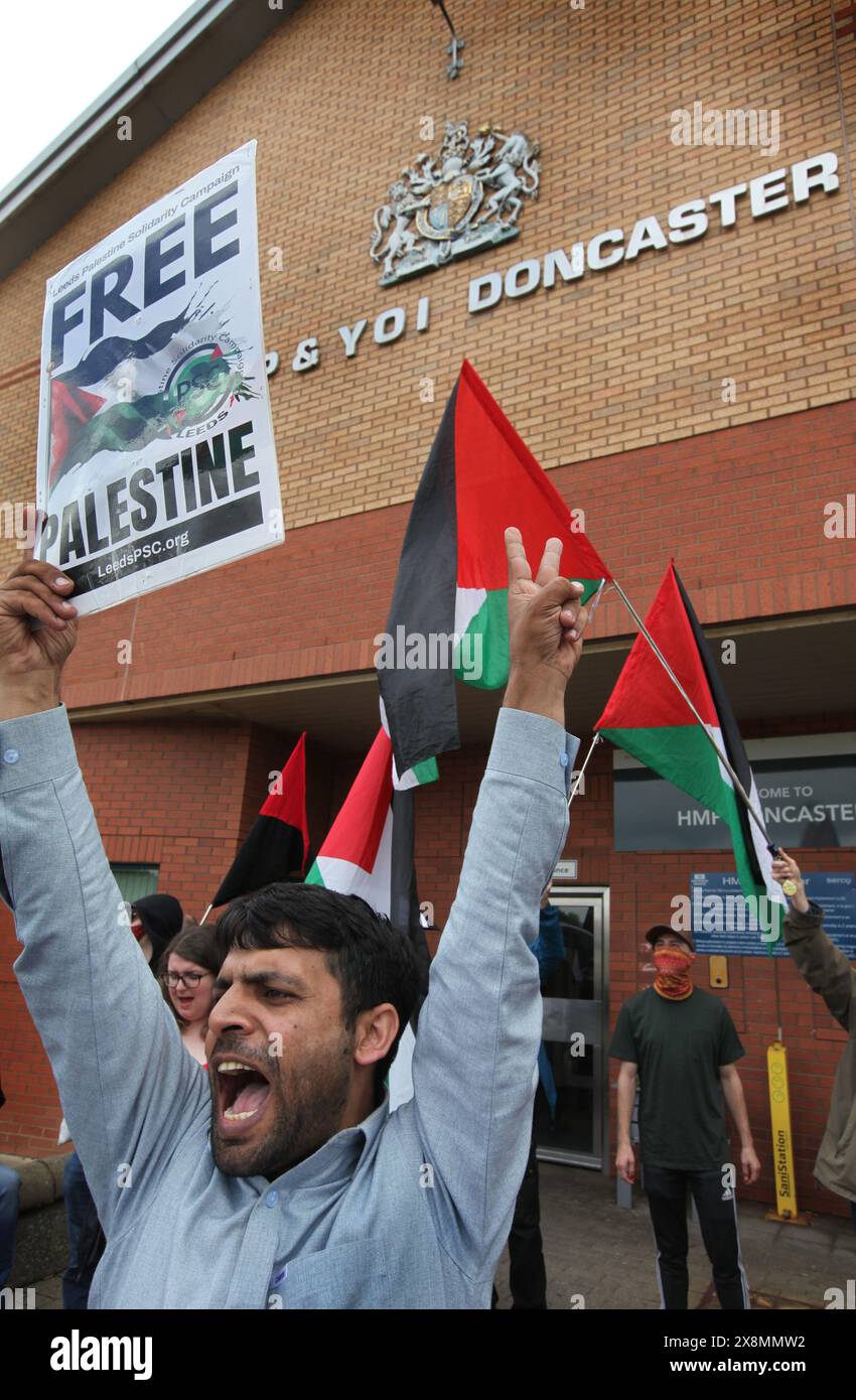 Doncaster, England, UK. 26th May, 2024. A protester shouts and holds up ...