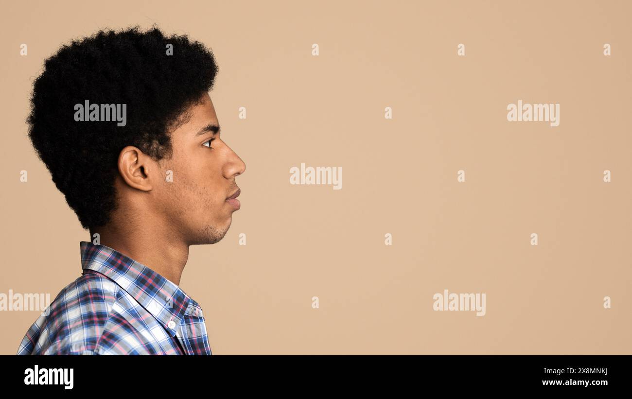 Profile portrait of afro teen guy over white background Stock Photo - Alamy