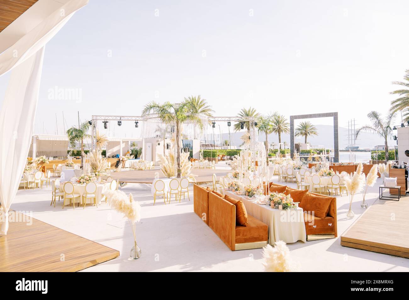 Festive tables stand around a stage on the open sunny terrace Stock ...