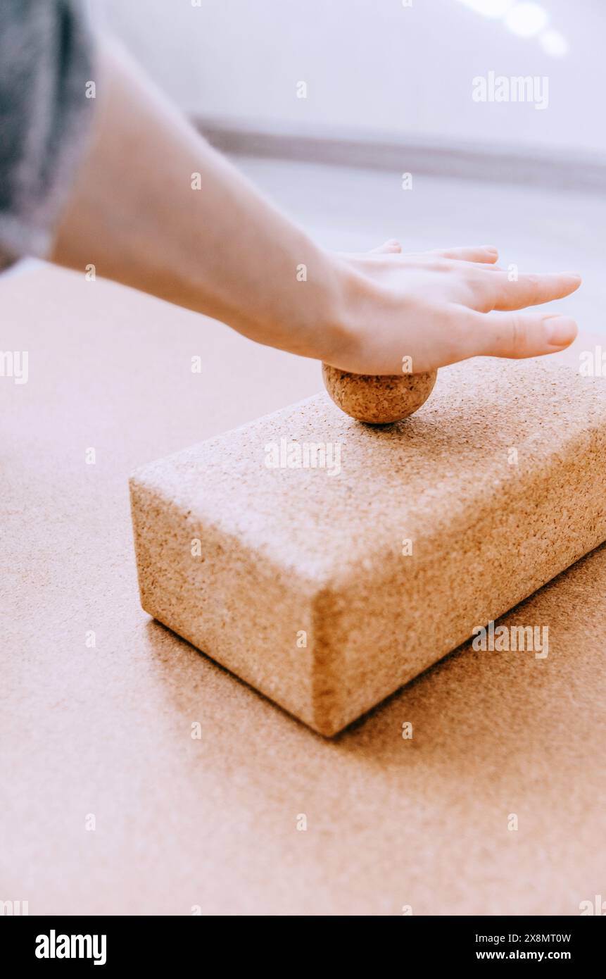 Close up of hand doing palm fascia release exercise with cork ball on ...
