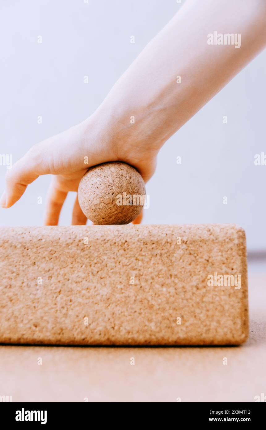 Close up of hand doing palm fascia release exercise with cork ball on ...