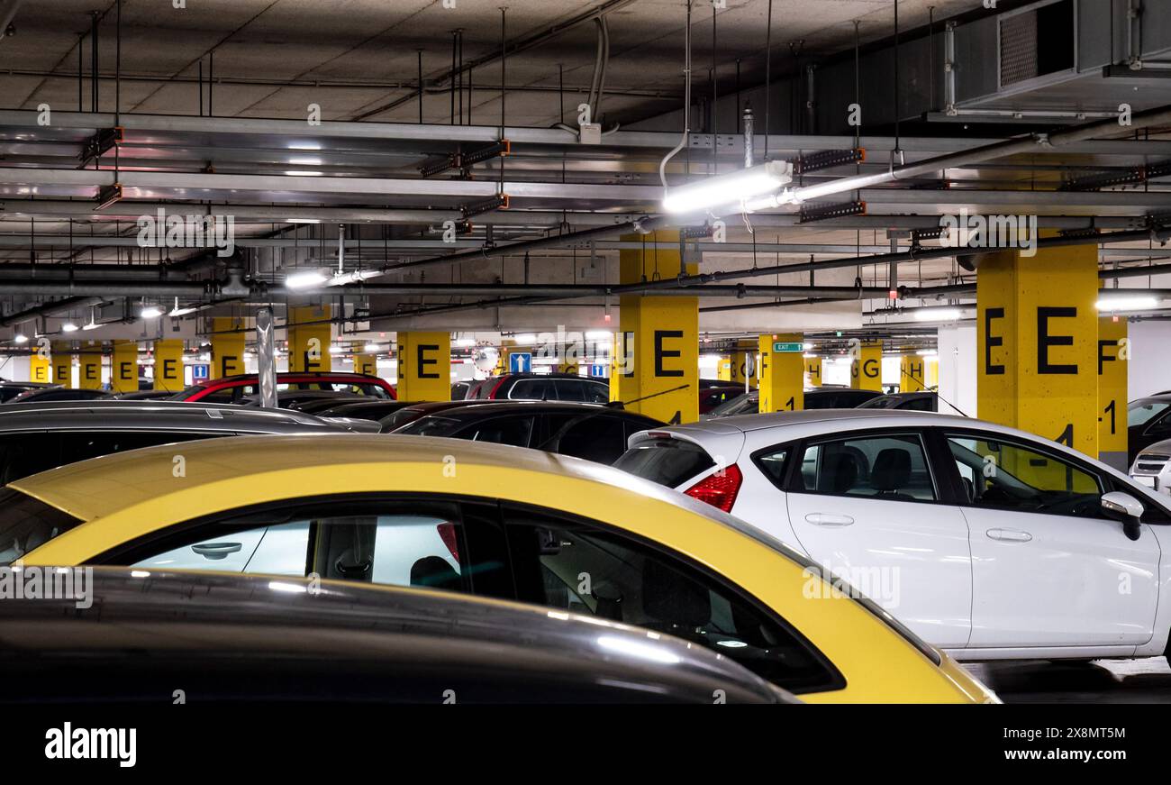 Underground garage in a shopping mall with a lot of cars and a visible ...