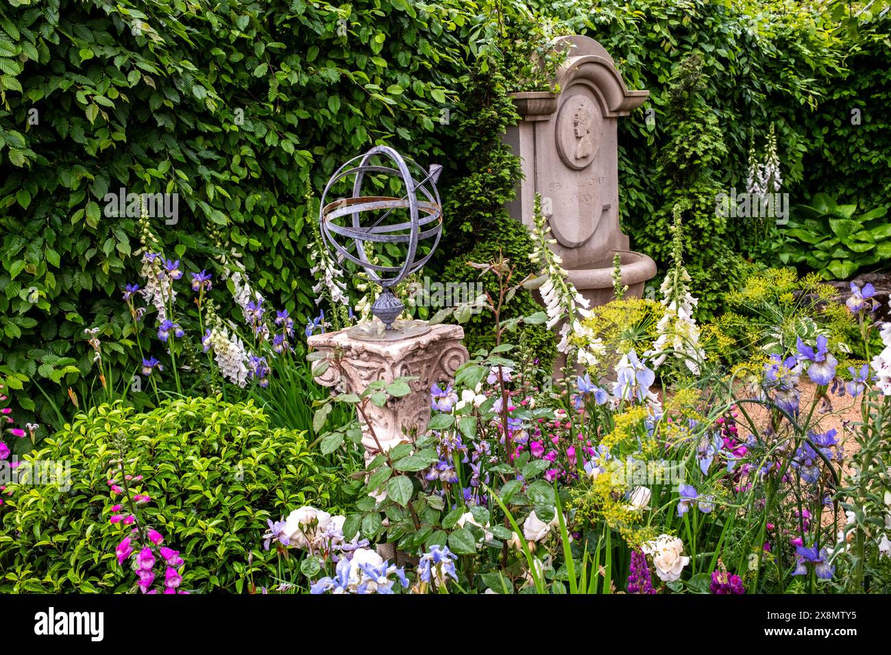 Water feature and statue in a pretty flower garden display at the 2024 ...