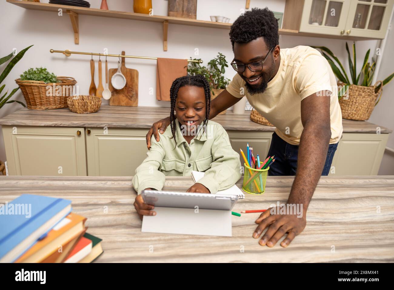 African American father and daughter doing homework together using tablet Stock Photo - Alamy