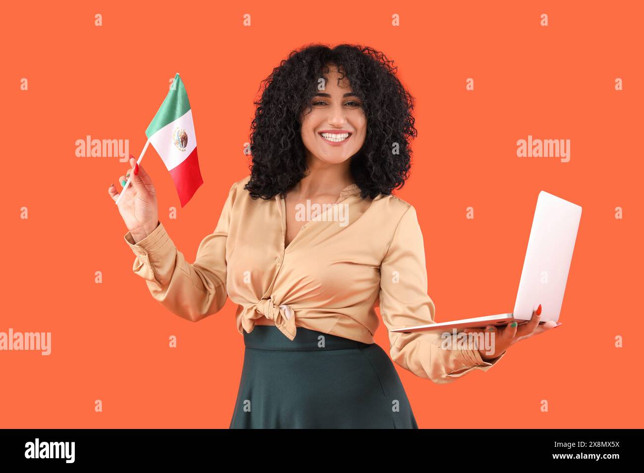 Beautiful woman with Mexican flag and laptop on orange background Stock ...