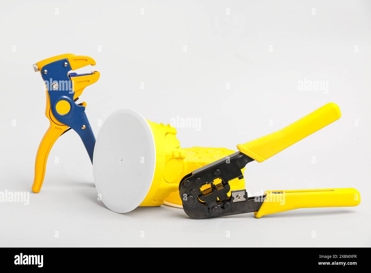 Wire strippers and plastic mounting boxes on light background Stock ...