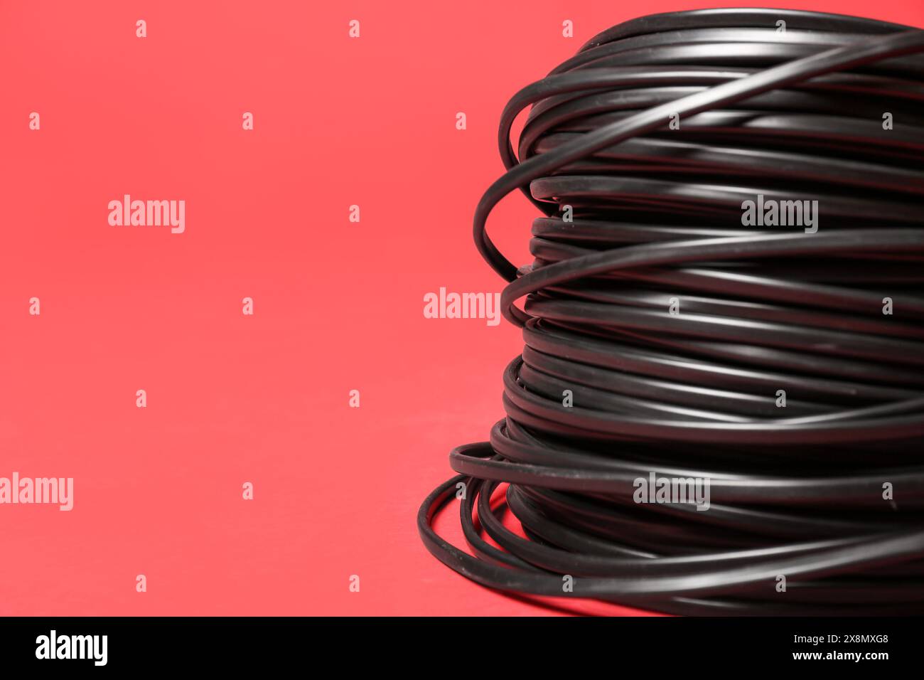 Rolled cables on red background, closeup Stock Photo - Alamy