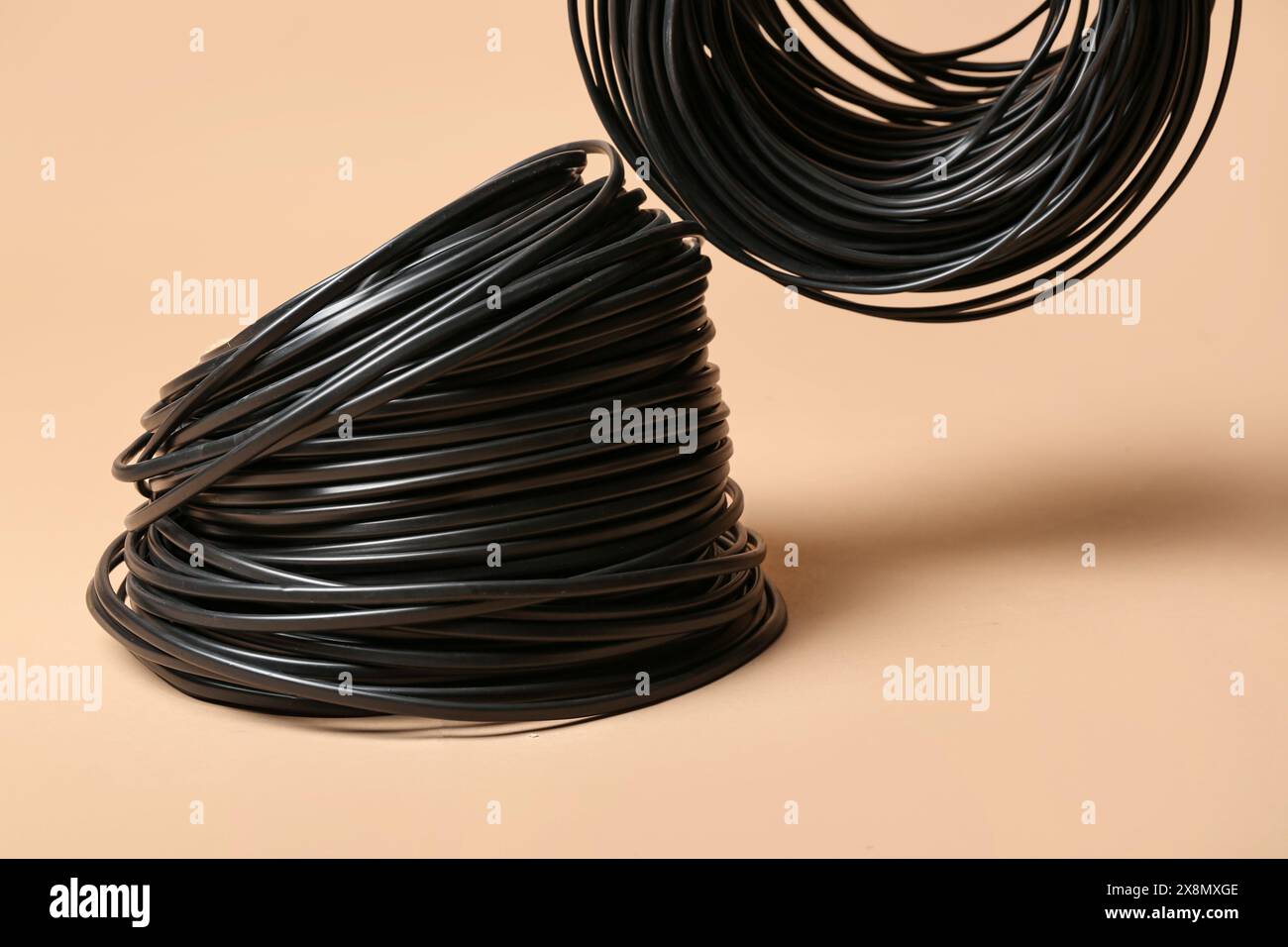 Rolled cables on beige background, closeup Stock Photo - Alamy