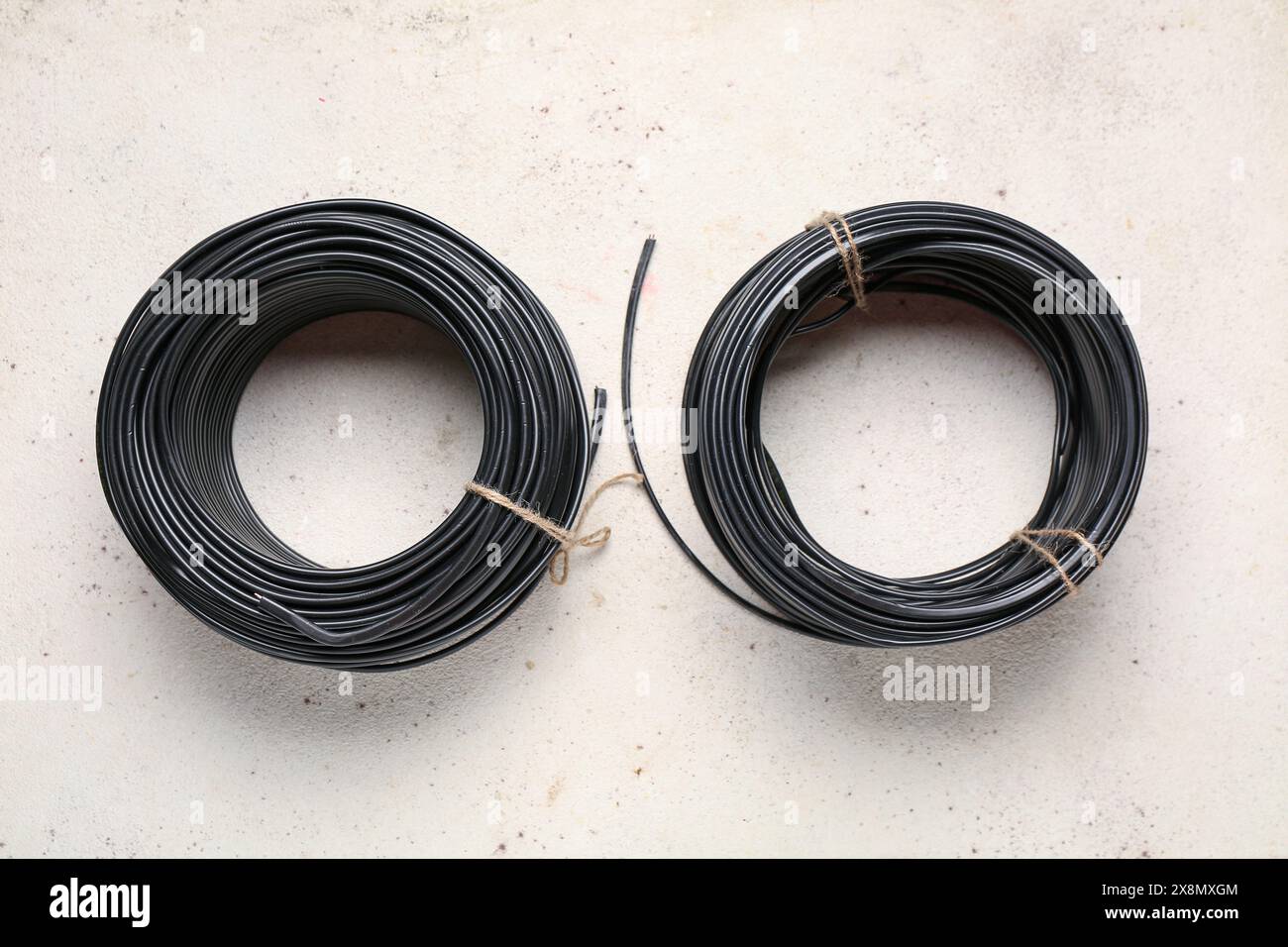 Black rolled cables on white grunge background Stock Photo - Alamy
