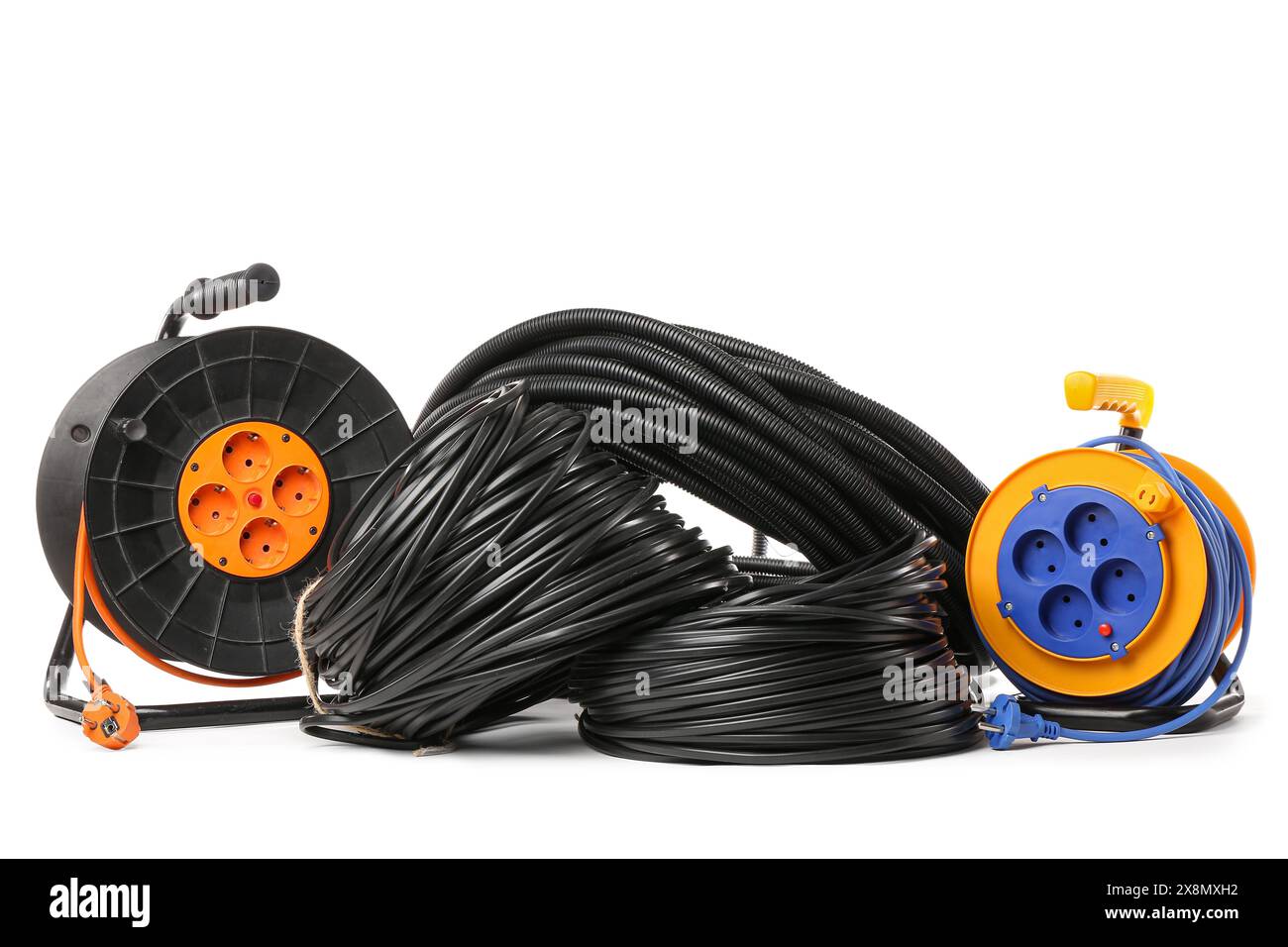 Rolled wires, flexible conduit tube and extension cable reels on white ...