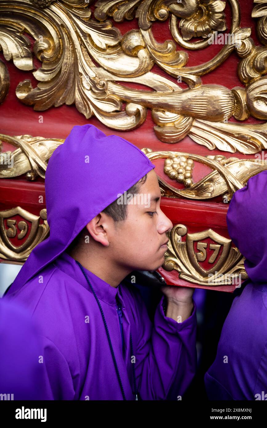 Close-up of young men and boys dressed in purple monks clothes caring ...