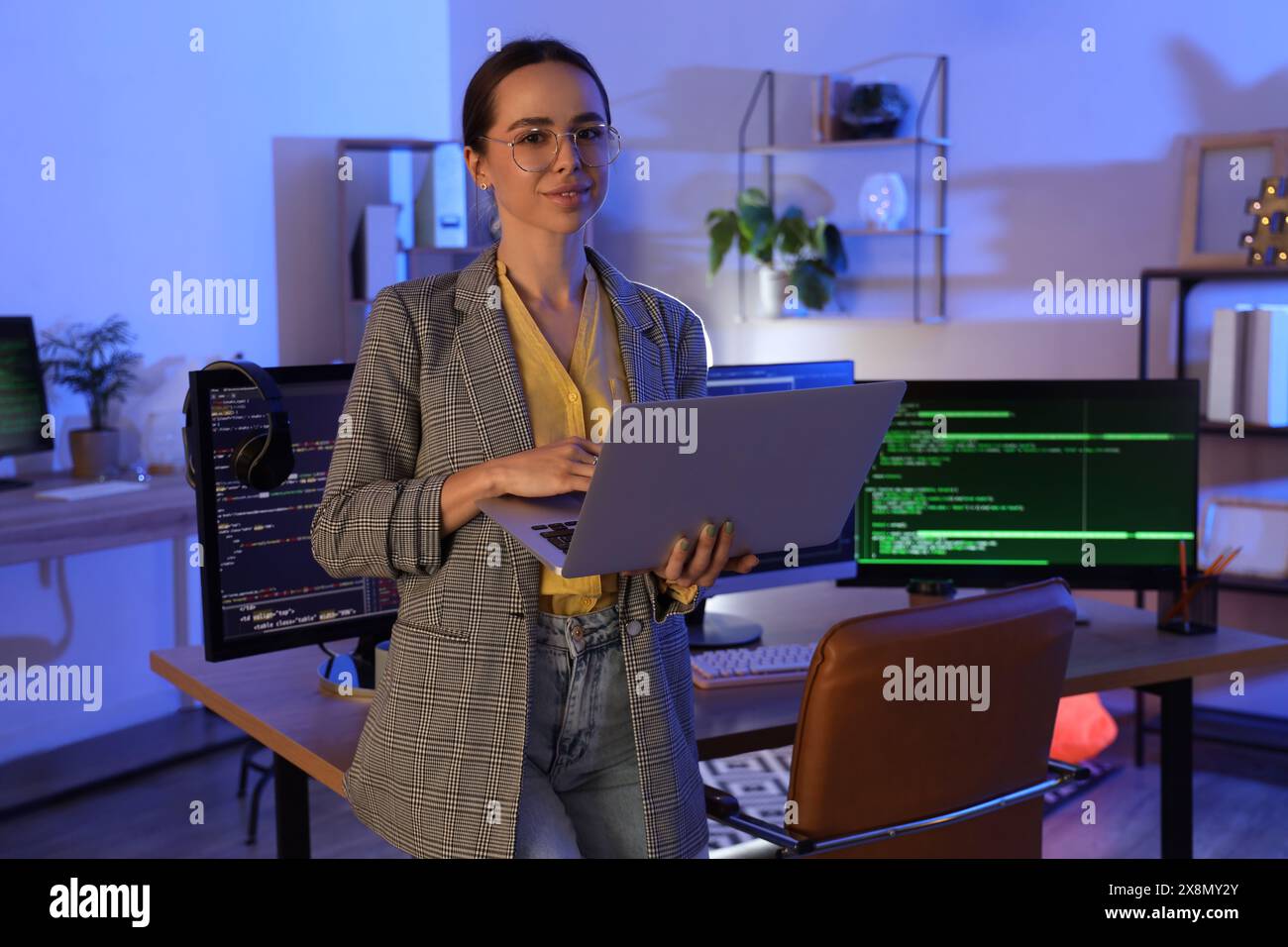 Beautiful programmer working with laptop in office at night Stock Photo ...