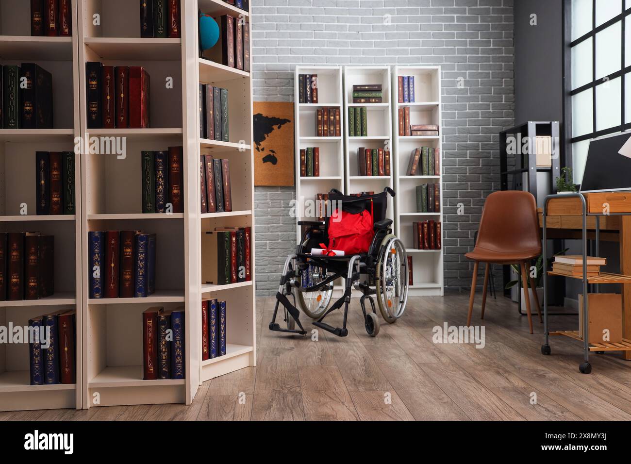 Wheelchair with diploma and backpack in library Stock Photo - Alamy