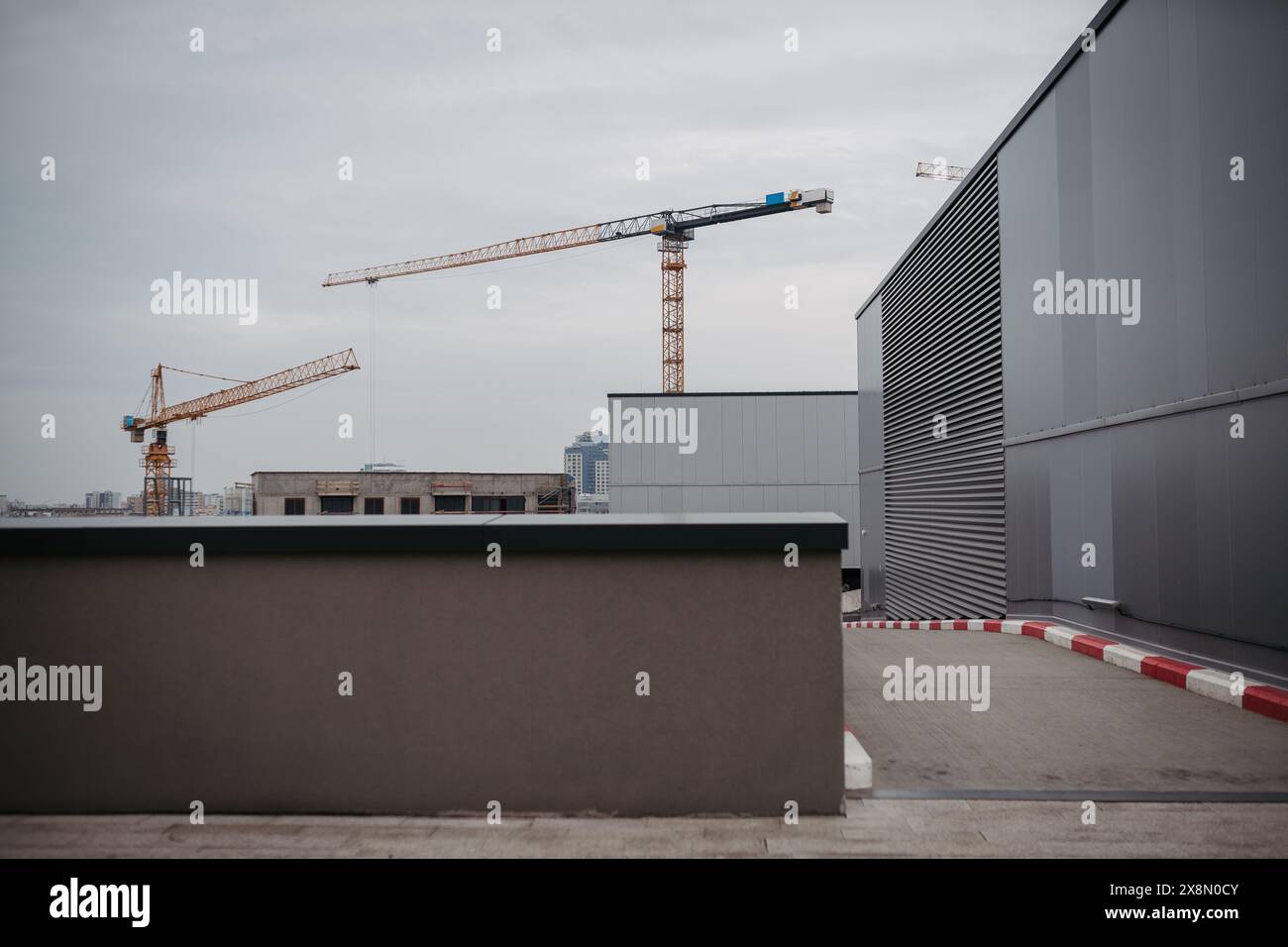 Construction site with buildings under construction with two cranes ...