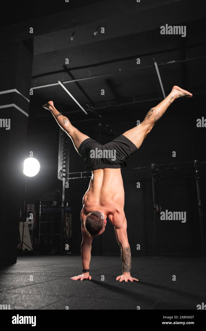 Rear view of handstand exercise, handstand push-ups. Routine workout ...