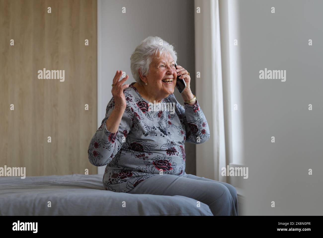 Senior woman at home, phone calling, sitting on bed. Older woman living ... Senior woman at home, phone calling, sitting on bed. Older woman living ...