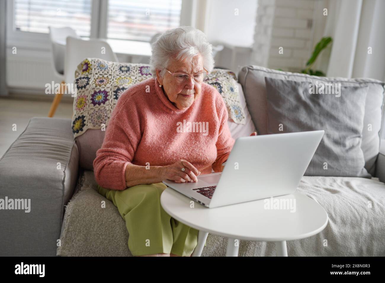 Online scams targeting seniors. Scammer sending email to elderly woman ...