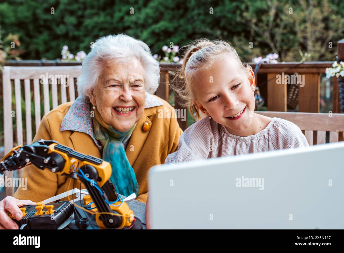 Grandmother supporting granddaughter in robotics, science, IT ...