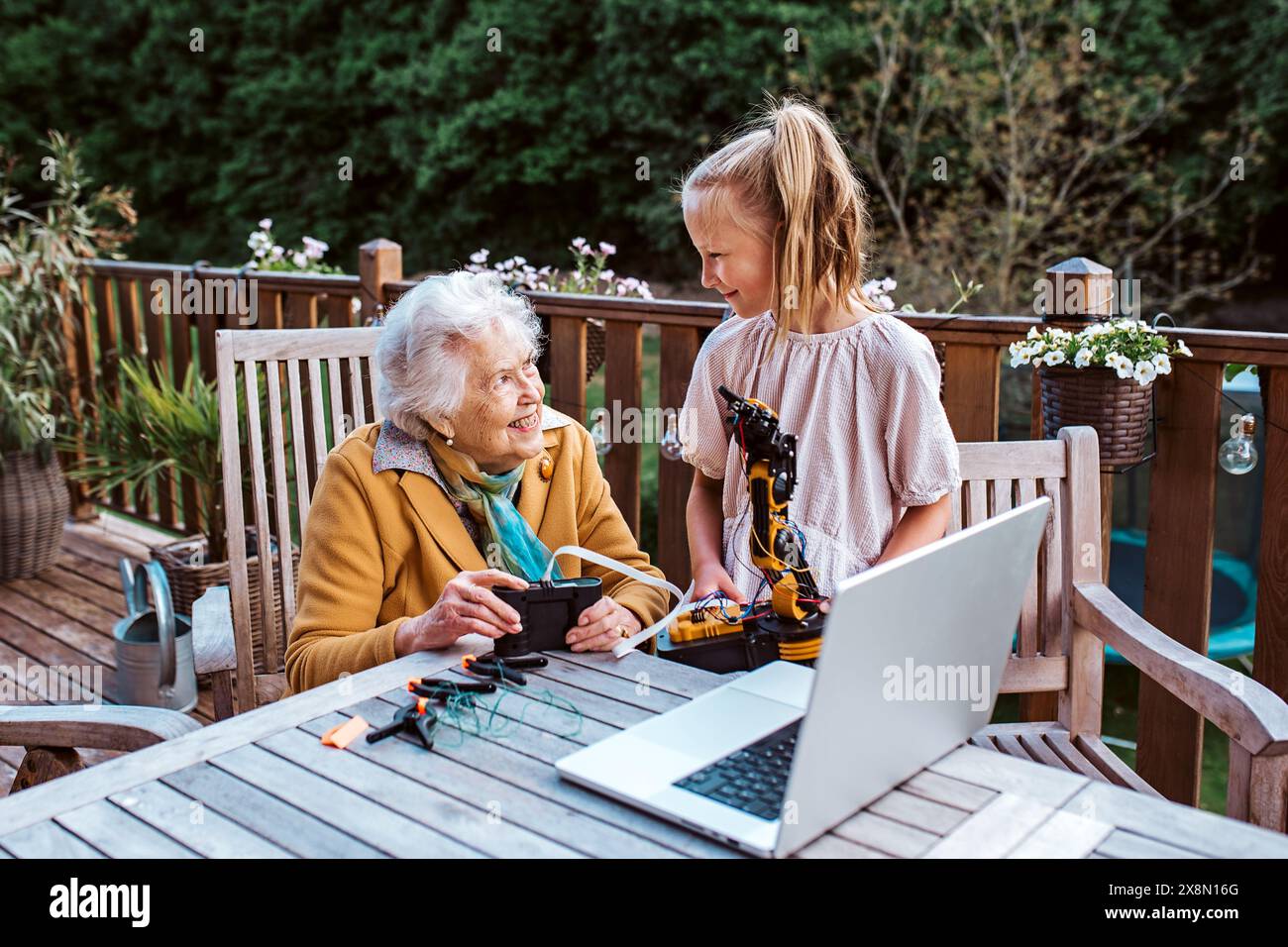 Grandmother supporting granddaughter in robotics, science, IT ...