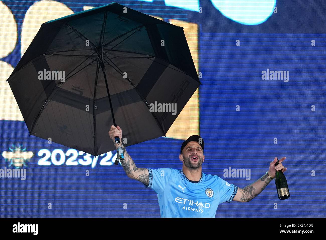 Manchester City's Kyle Walker celebrates with an umbrella during a ...