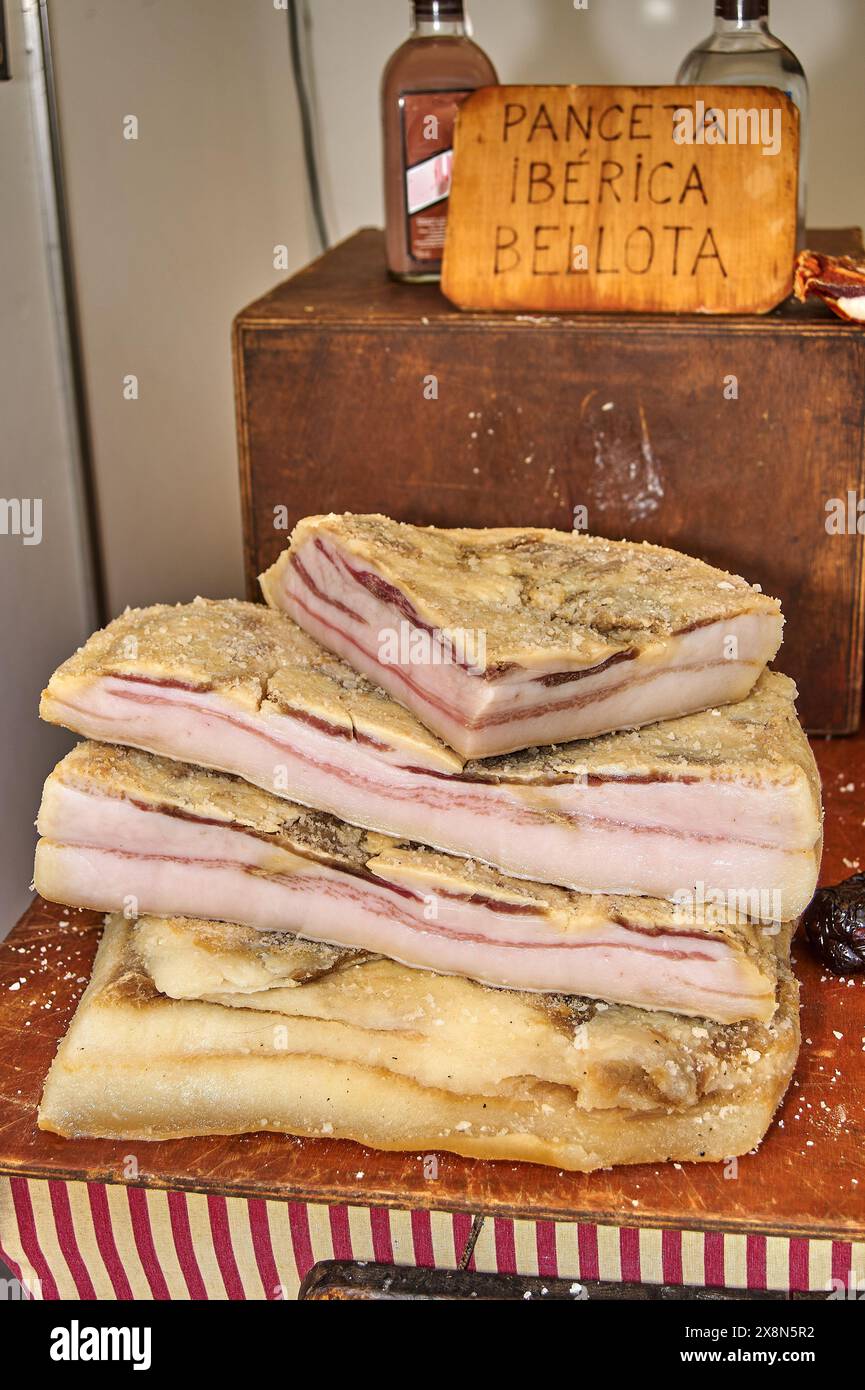 Close-up of stacked cured bacon, with a crystalline texture indicating ...