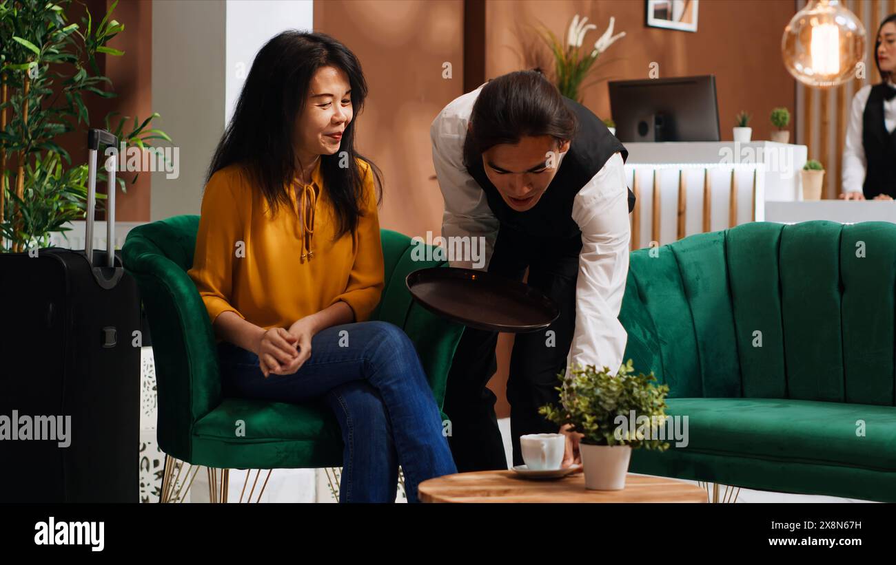 Woman paying coffee cup at pos terminal in lounge area, using credit ...