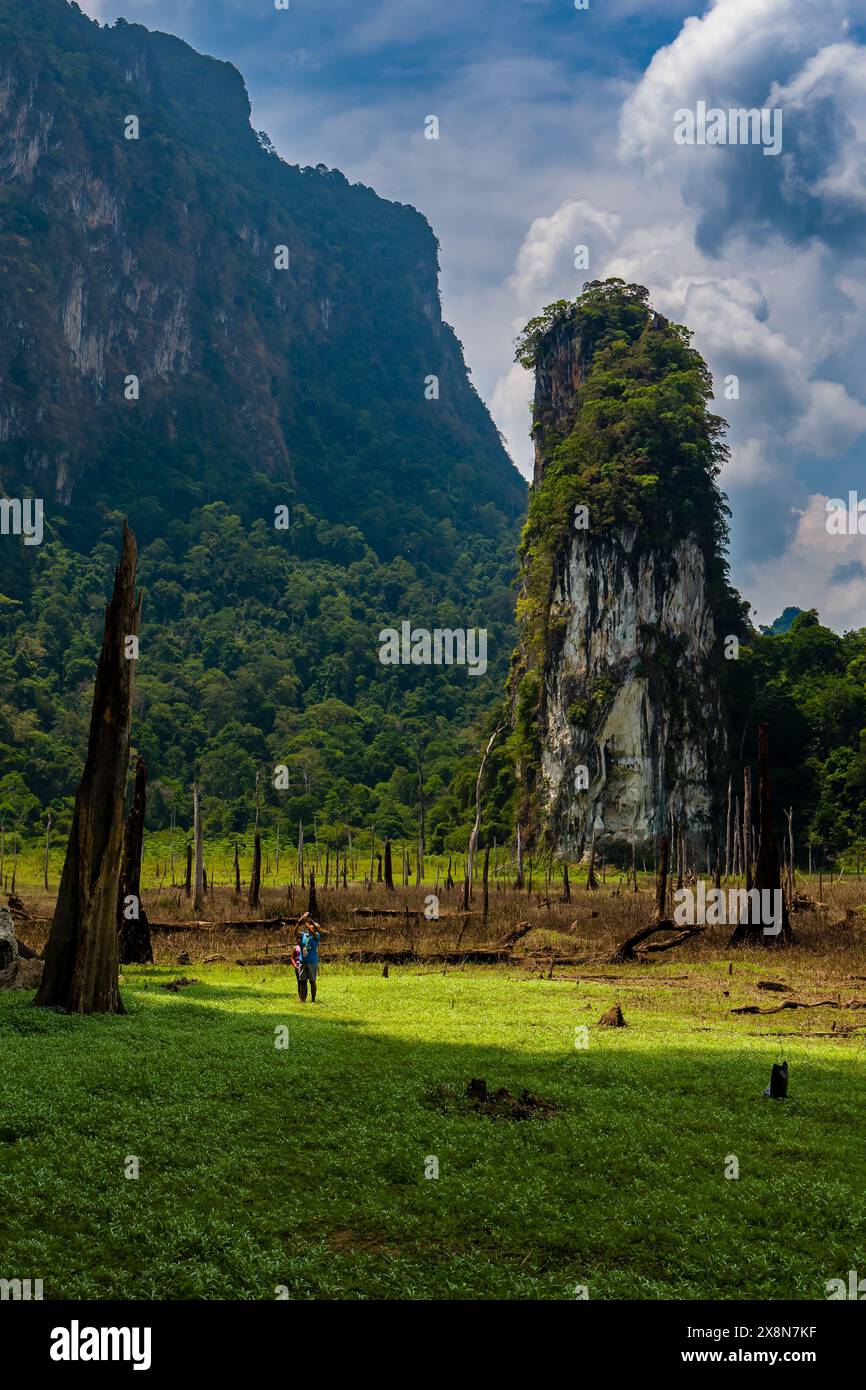 Hikers and tourists exploring the tropical rainforest and karst ...