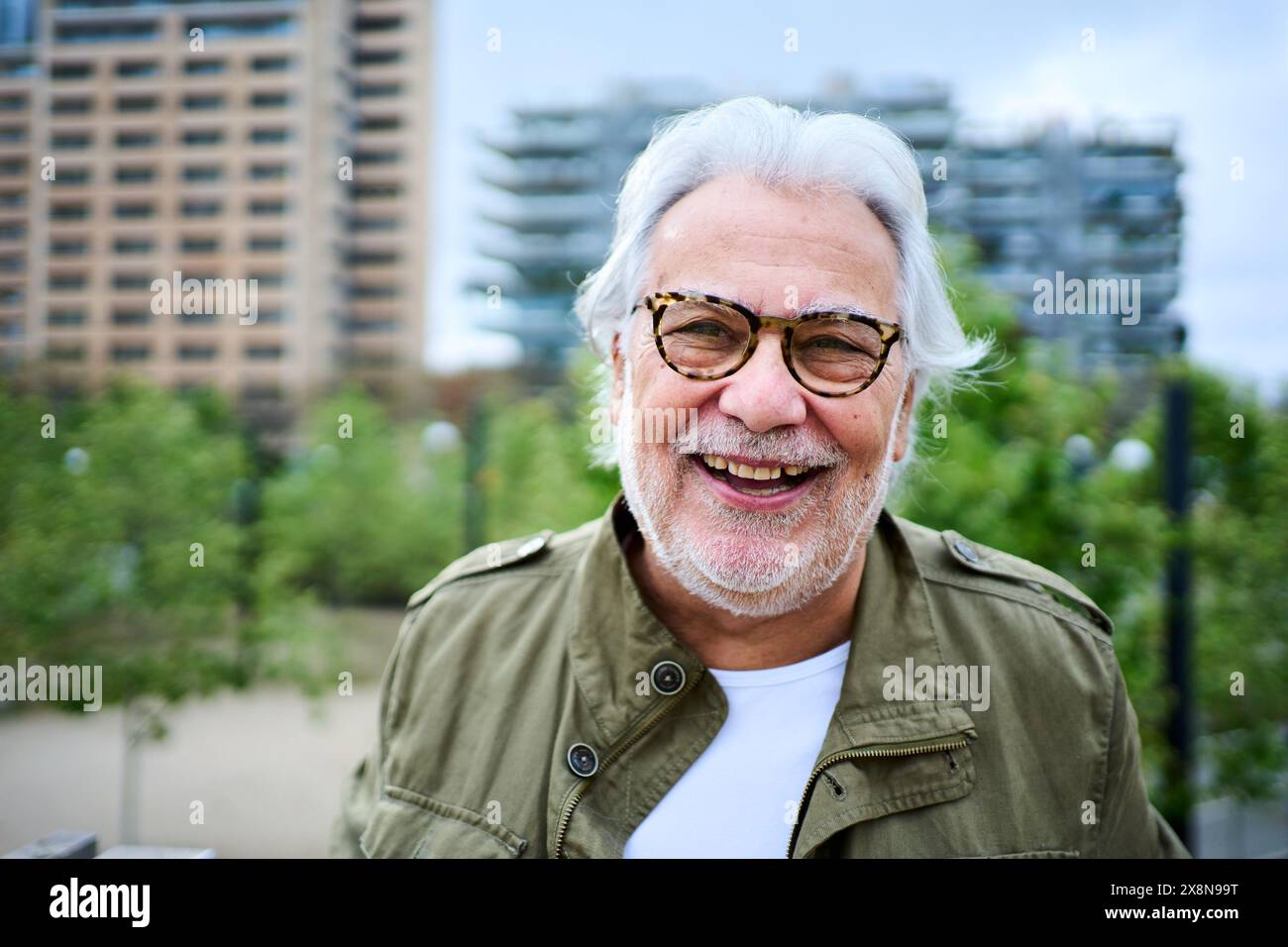 Portrait of happy mature Caucasian senior man standing outdoors with ...