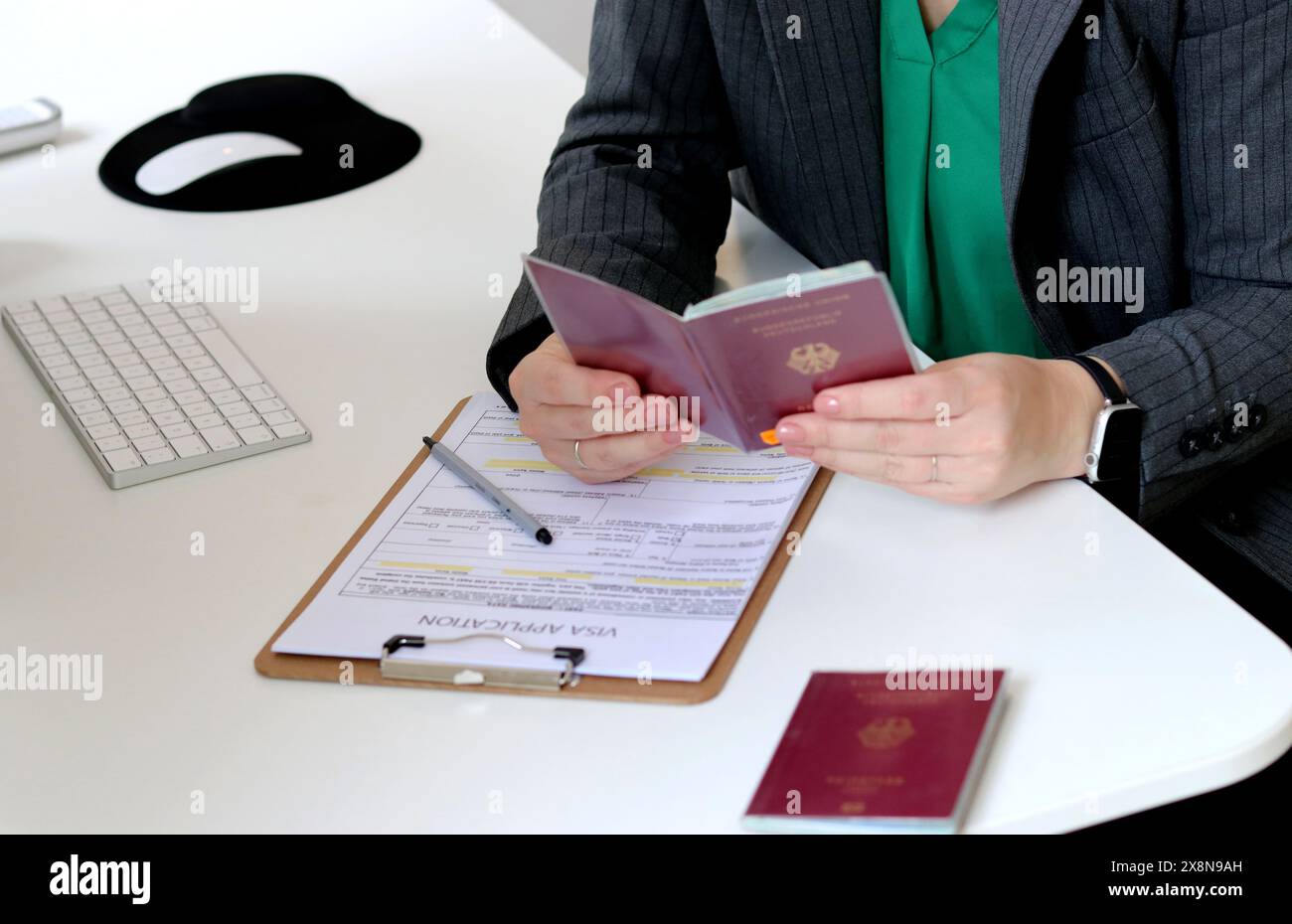 Top view of a woman filling out visa application documents with a ...