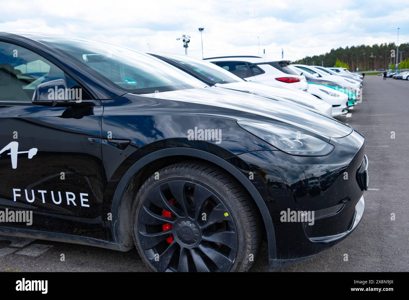Many Tesla electric cars on street parking lot, Automotive industry in ...