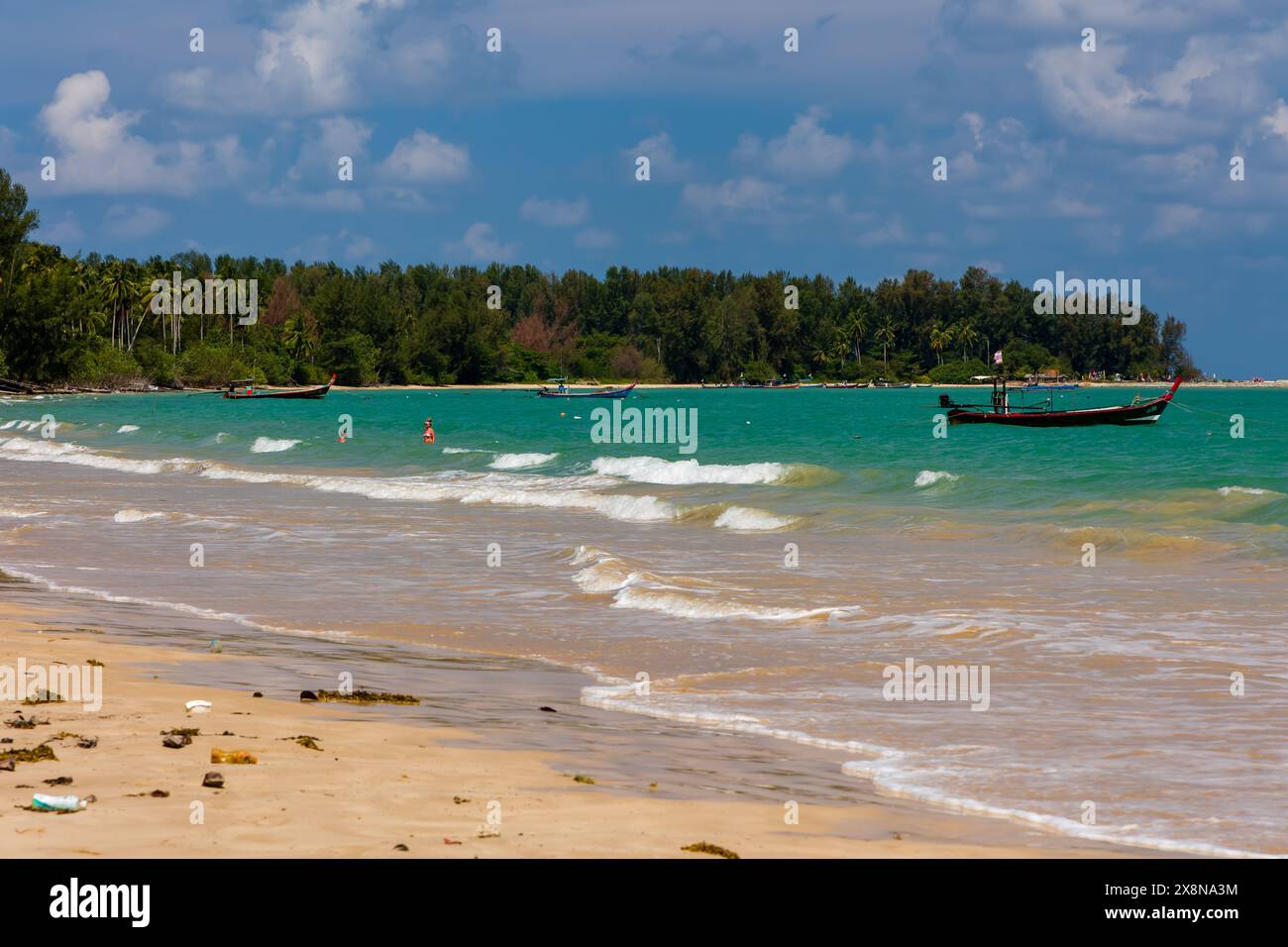 Plastic trash and other discarded items on the high tide line of a ...