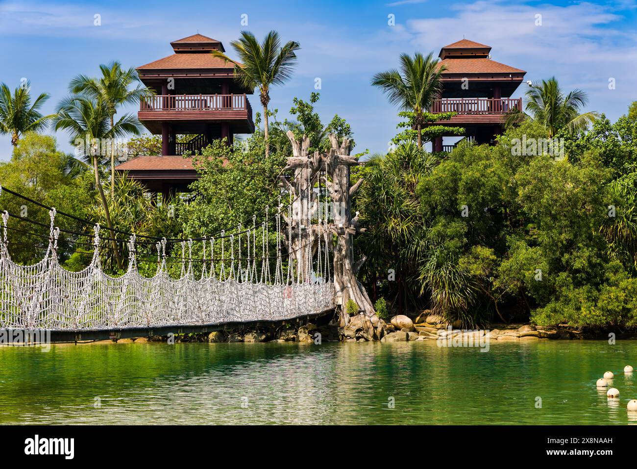 Rope suspension bridge and lush vegetation at Palawan Beach, Sentose ...