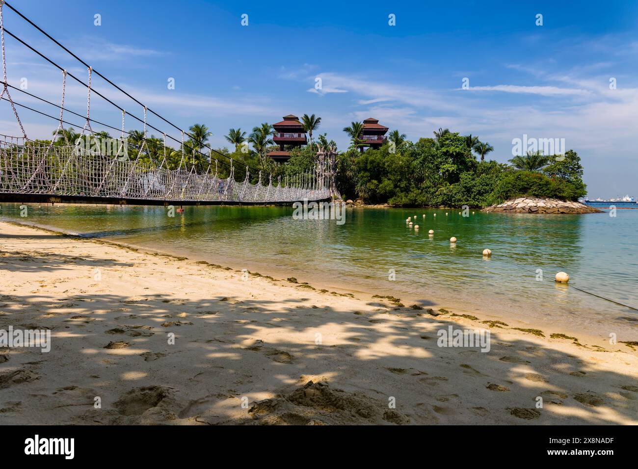 Rope suspension bridge and lush vegetation at Palawan Beach, Sentose ...