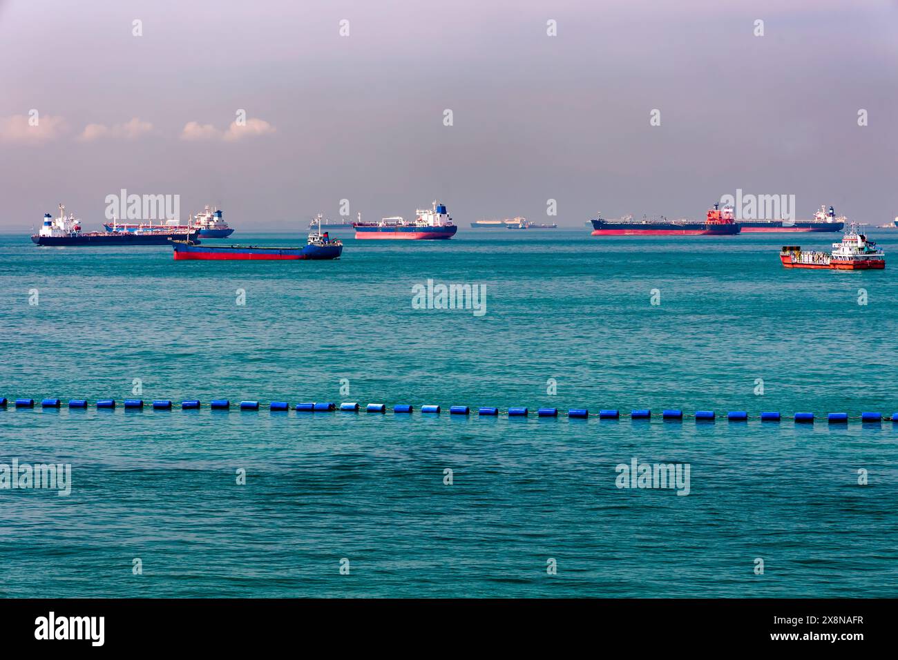 Large numbers of ships waiting at anchor off the coast of Singapore and ...