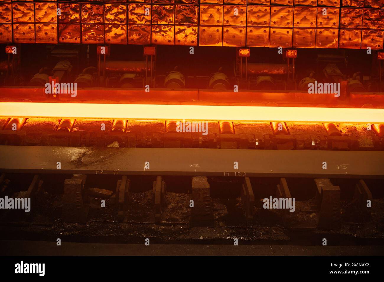 Rolled metal factory. Hot iron slab moving on conveyor of metal rolling ...