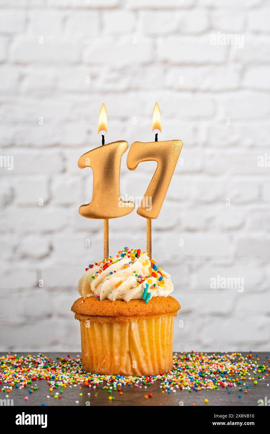 Golden birthday candle number 17 with cupcake - White block wall ...